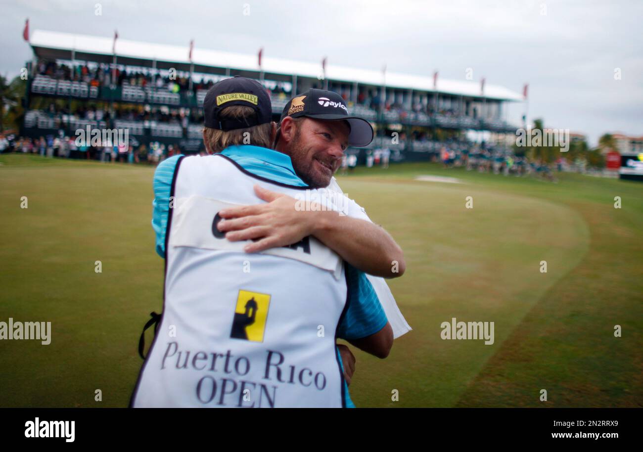 Germany's Alex Cejka, behind, hugs his caddie after winning the Puerto ...