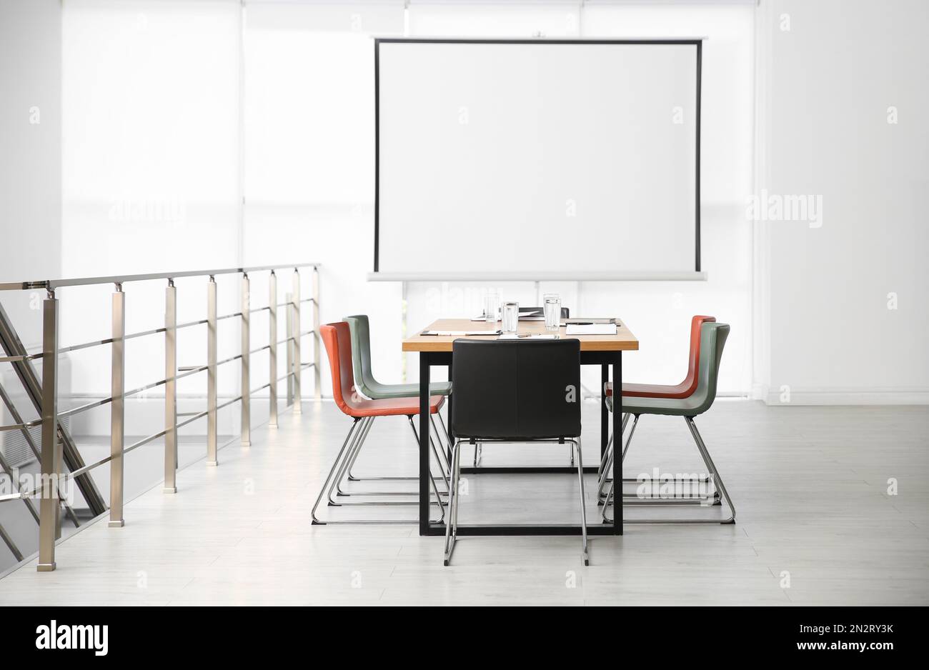 Modern meeting room interior with large table and projection screen ...
