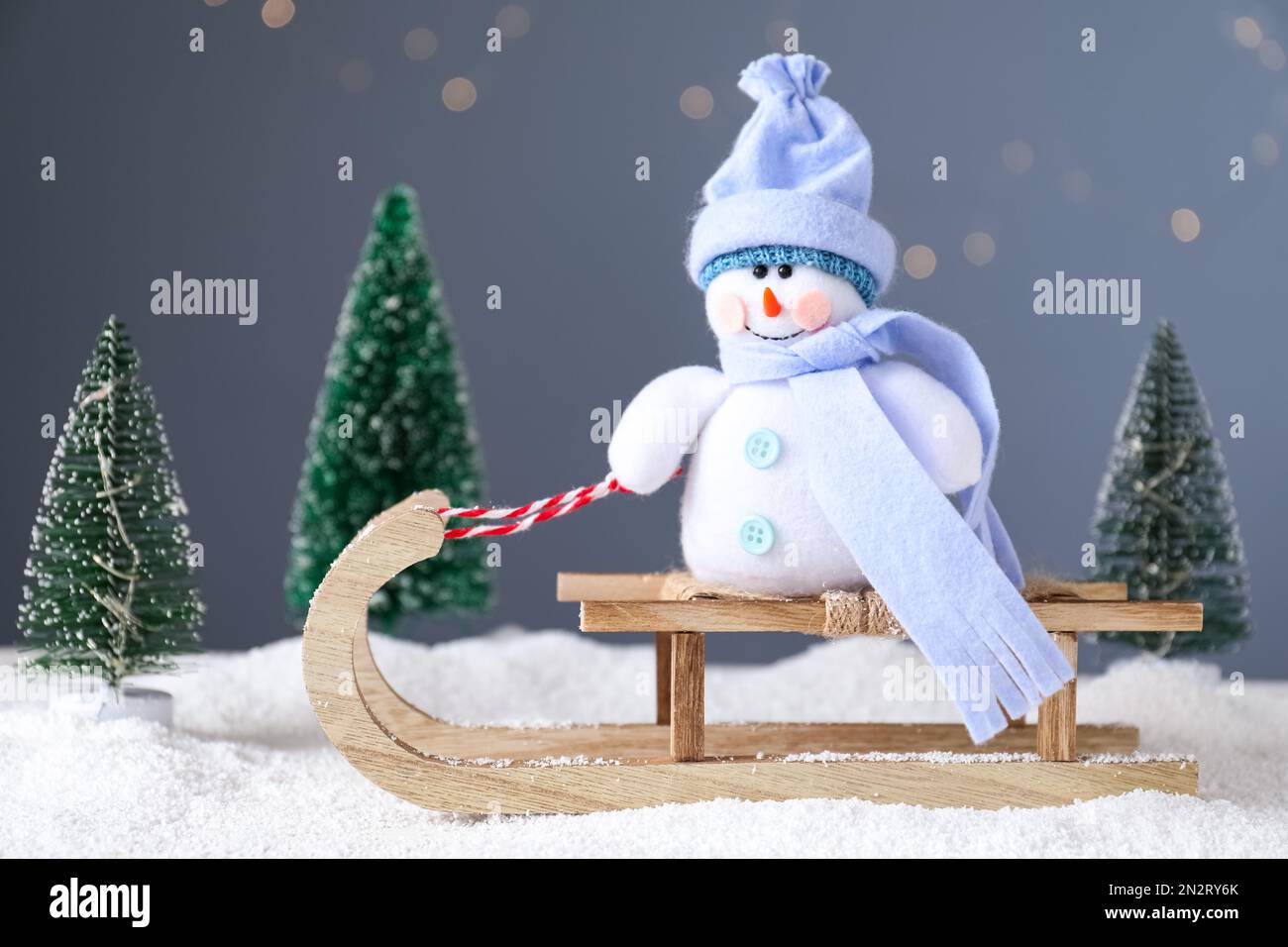 Sleigh with toy snowman on pile of snow Stock Photo - Alamy