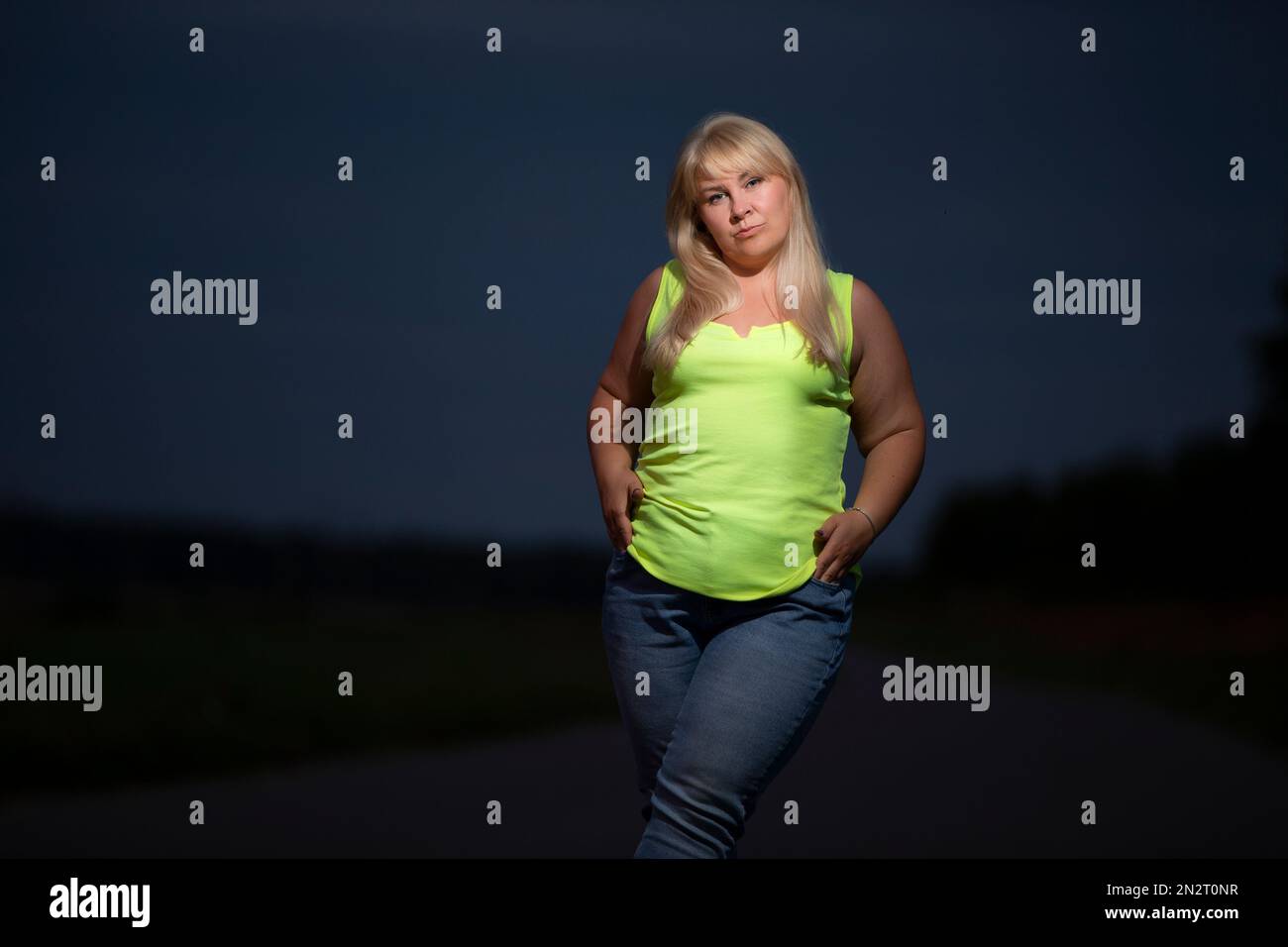 Chubby middle aged woman posing in jeans outdoors, overweight xxl Stock ...
