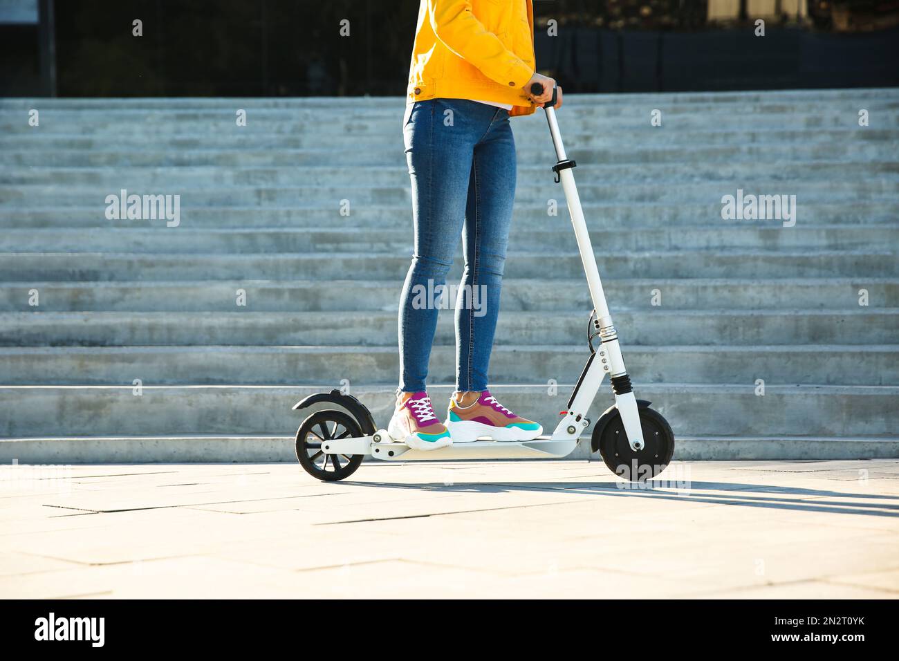 Adult riding scooter on pavement hi-res stock photography and images ...