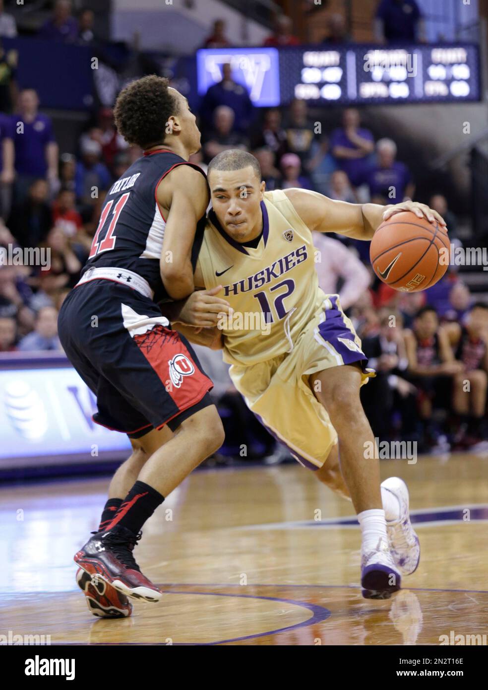 Washington's Andrew Andrews (12) drives against Utah's Brandon Taylor ...