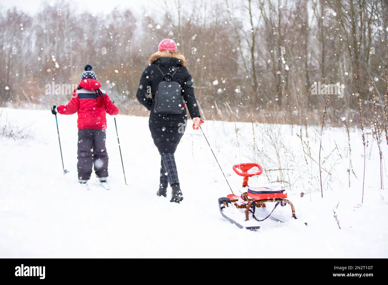 Boy pushing sled hi-res stock photography and images - Alamy