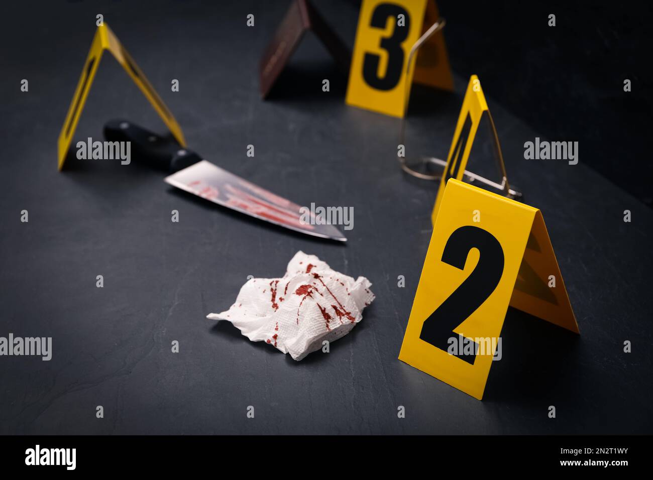 Crime scene markers and evidences on black background Stock Photo - Alamy