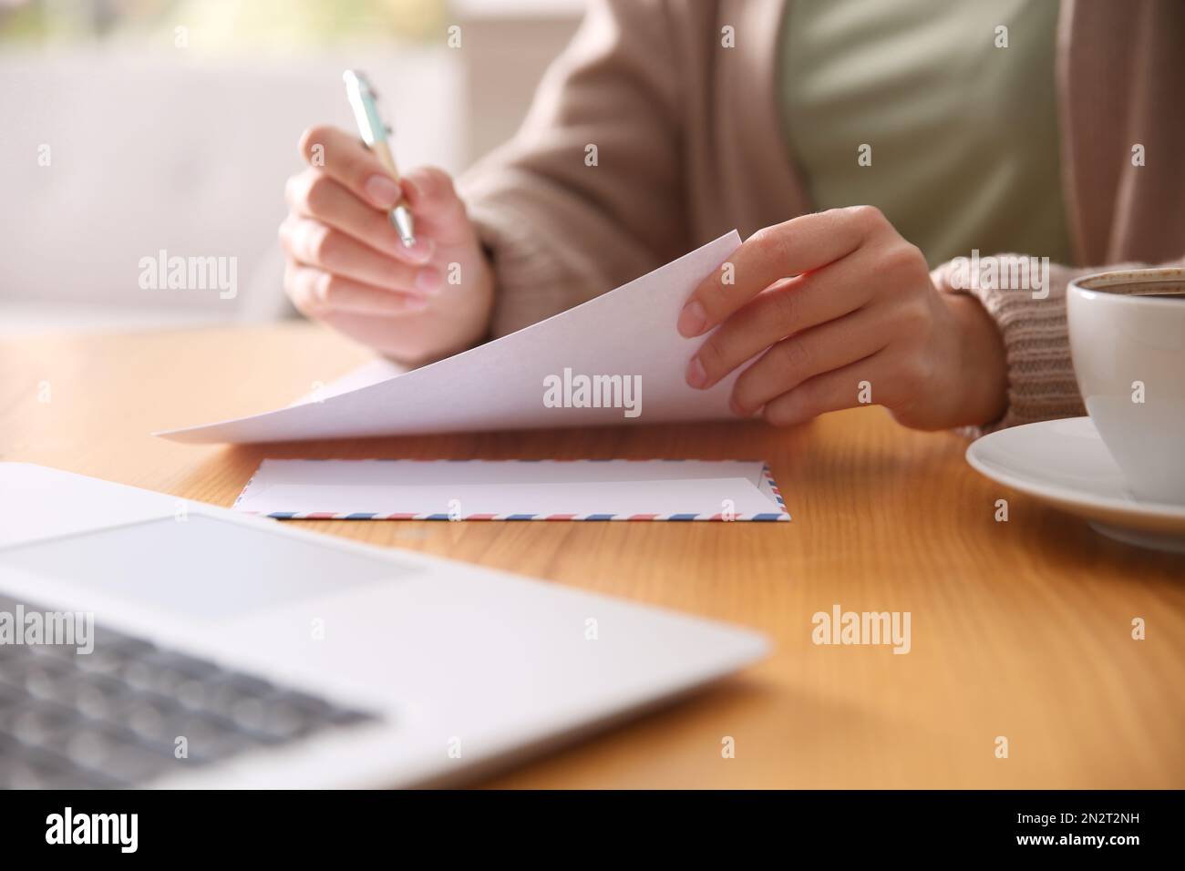 Woman writing letter with envelope hi-res stock photography and images ...