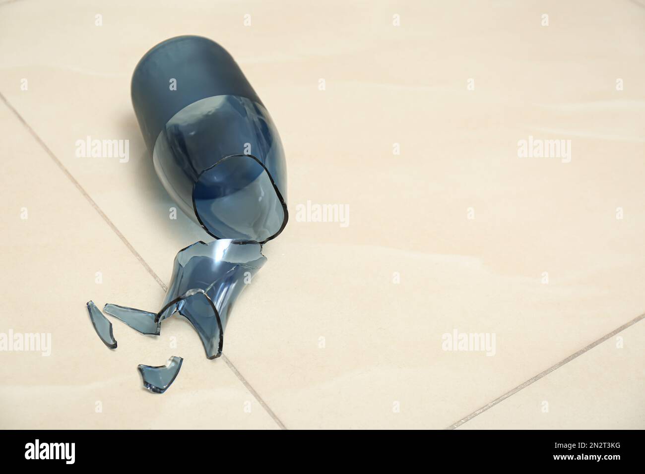 Broken blue glass vase on floor. Space for text Stock Photo - Alamy