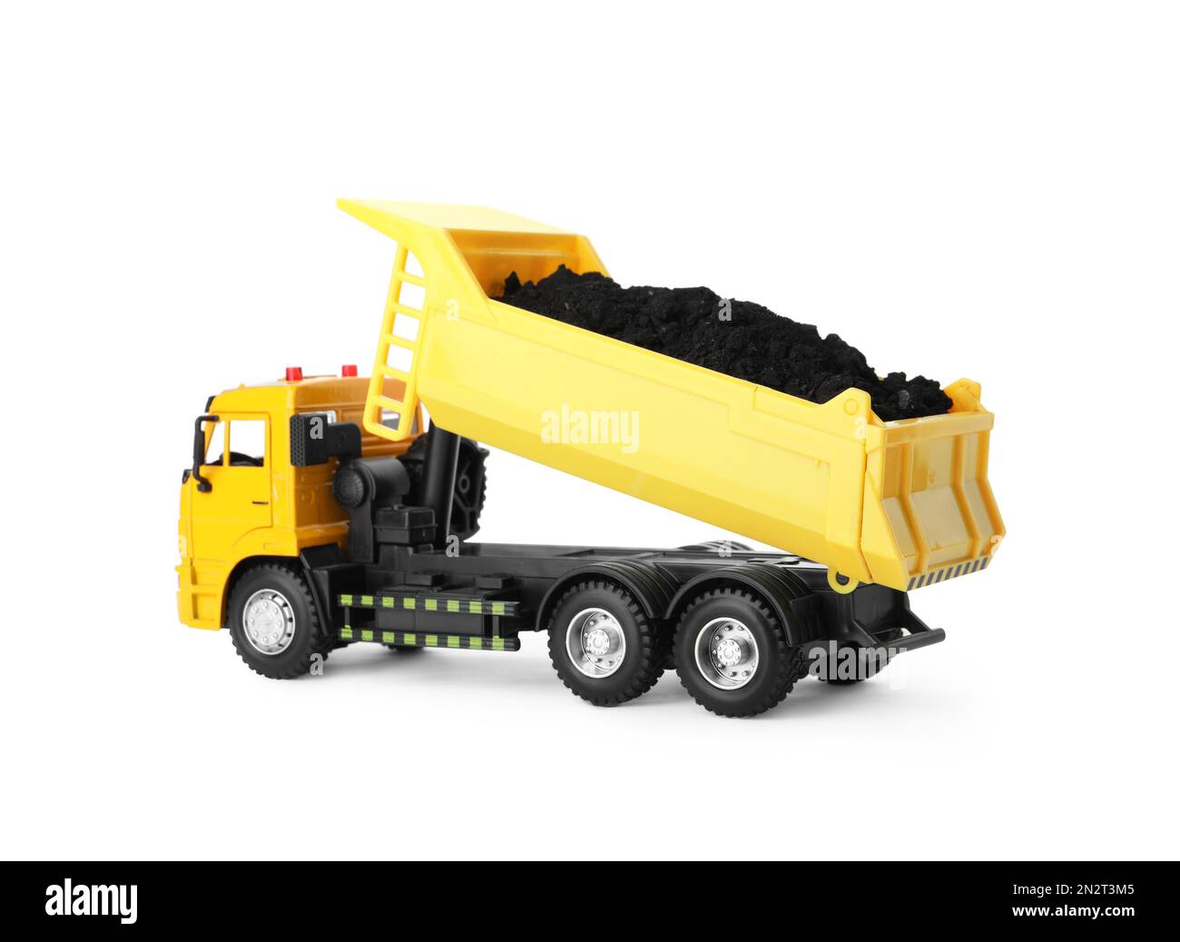 Yellow toy tipper truck with coal isolated on white Stock Photo - Alamy