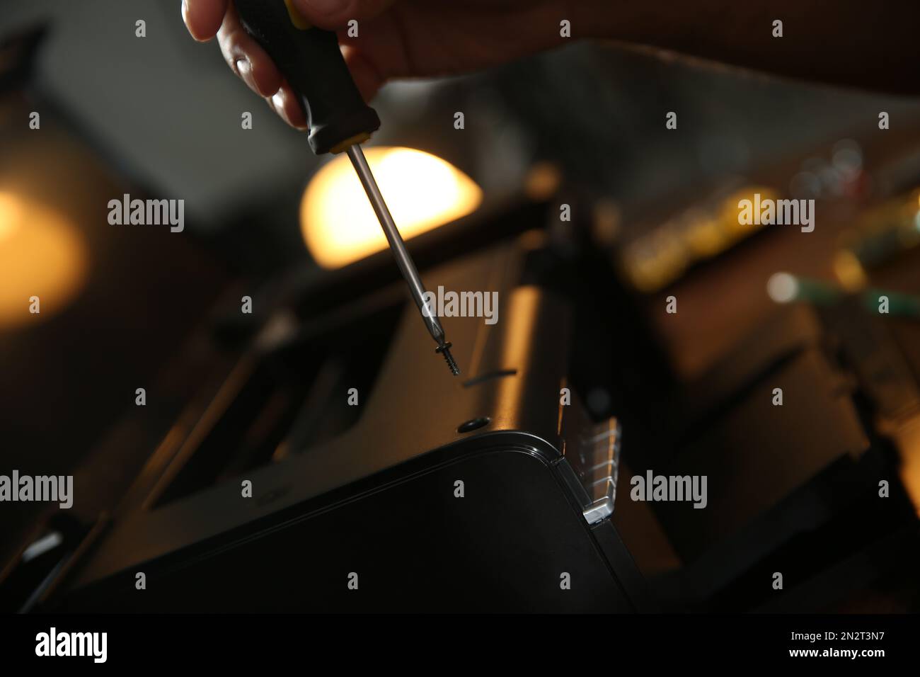 Repairman with screwdriver fixing modern printer, closeup Stock Photo ...