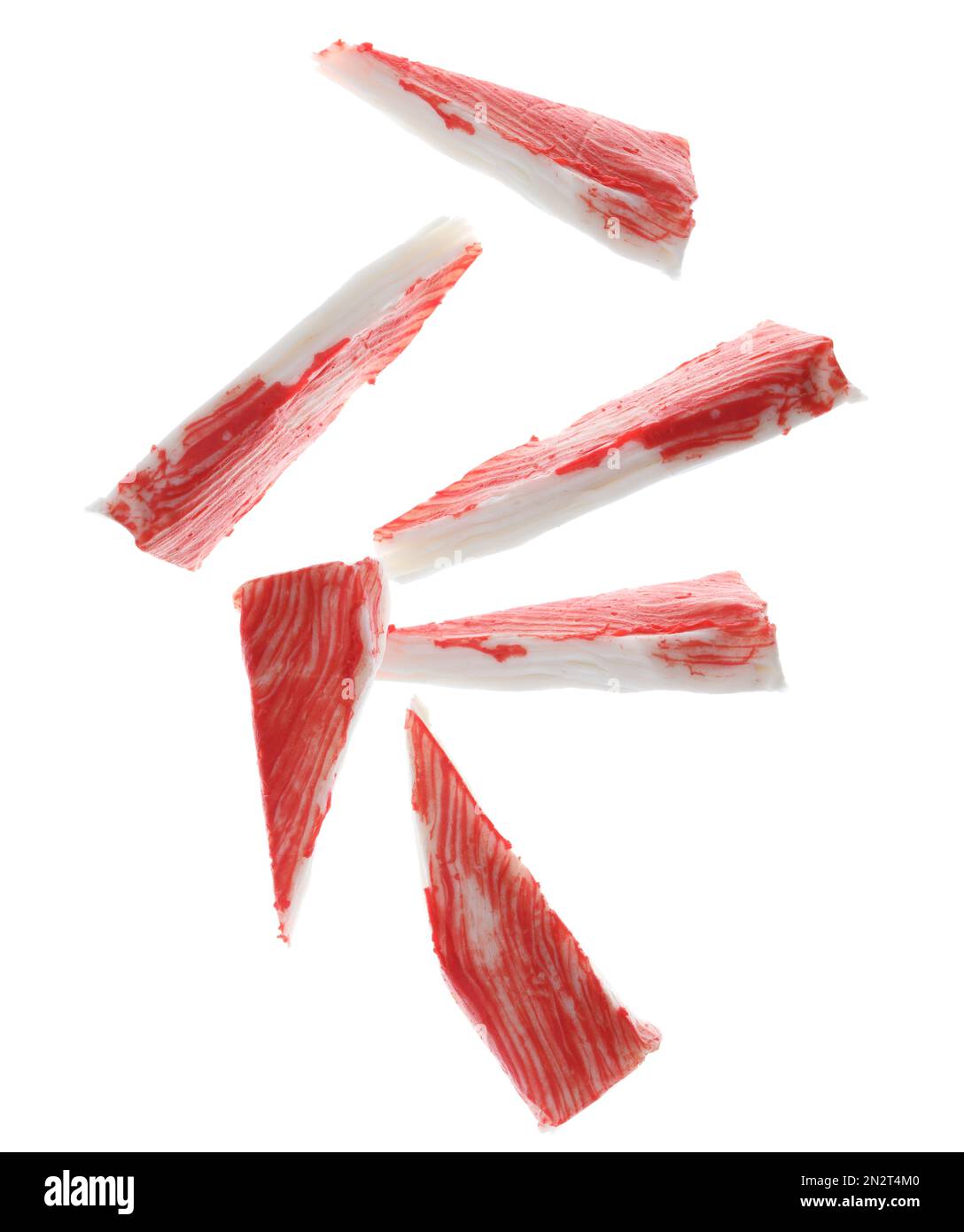 Cut fresh crab sticks falling on white background Stock Photo - Alamy