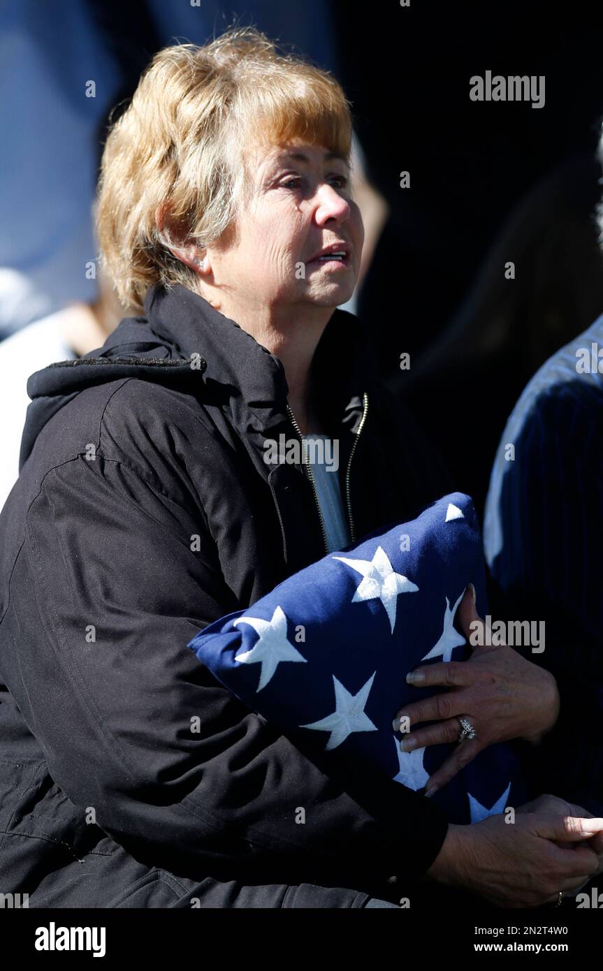 A tear runs down the right cheek of Joann Mueller after she accepted ...