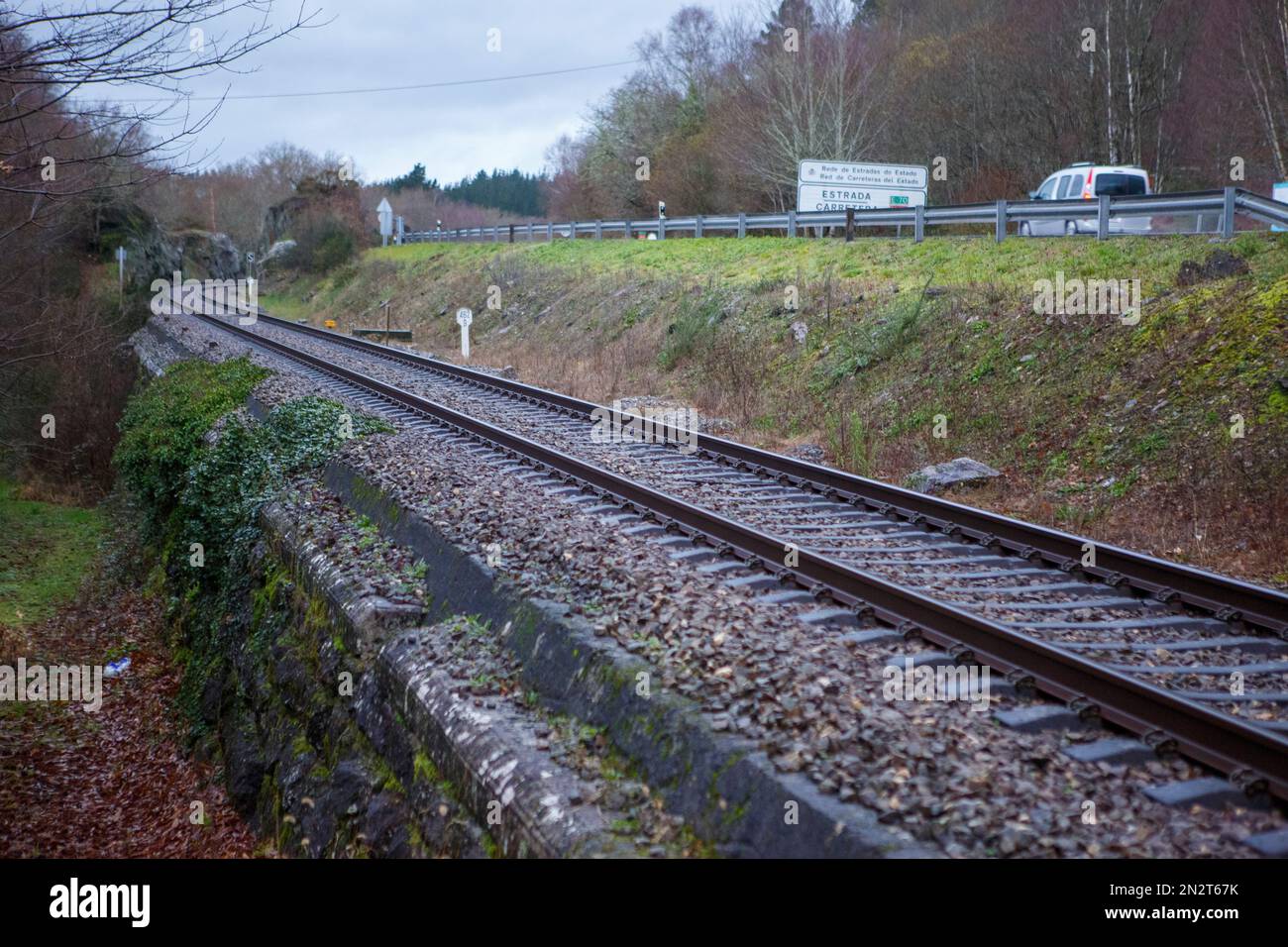 Empty train track parallel to road with van driving Stock Photo - Alamy