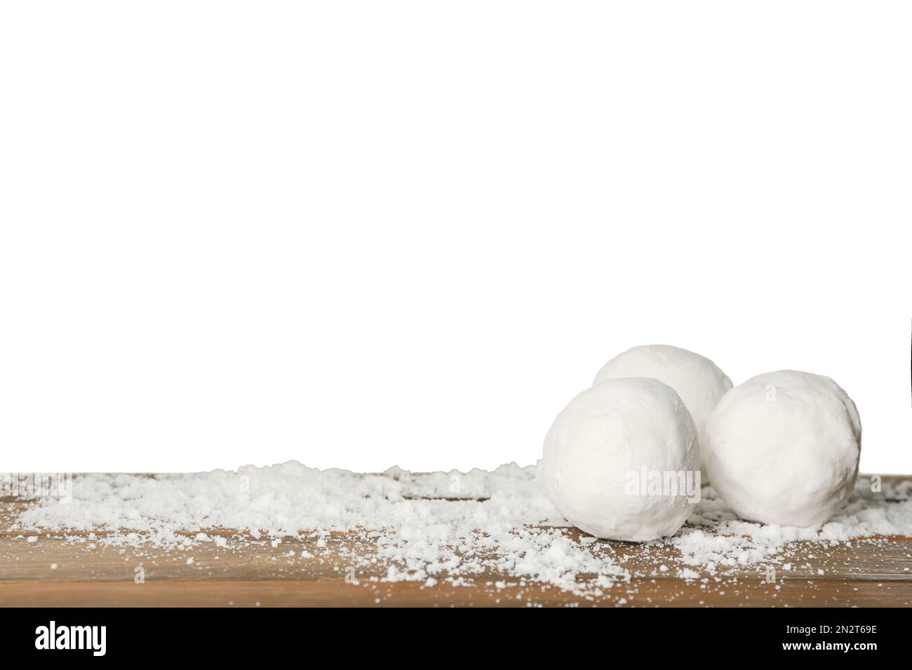 Snowballs on wooden table against white background. Space for text ...