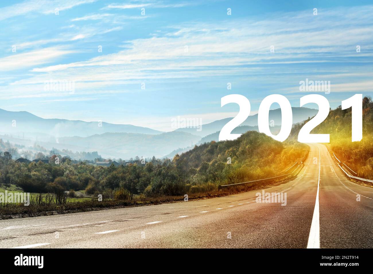 Start new year with fresh vision and ideas. Asphalt road leading to ...