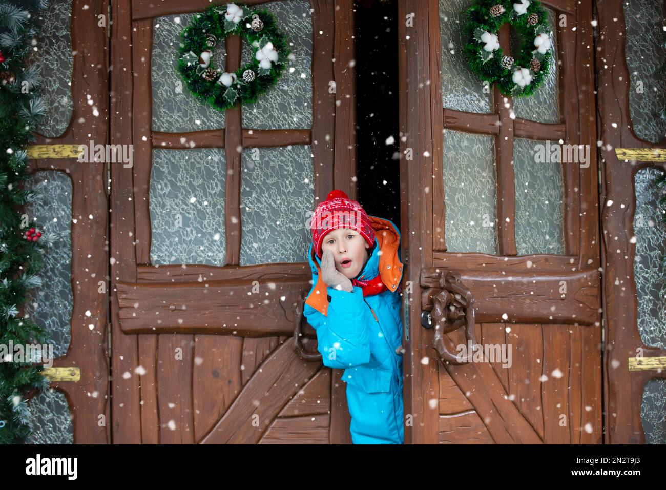Child boy welcomes guests, surprised, the house is decorated before ...