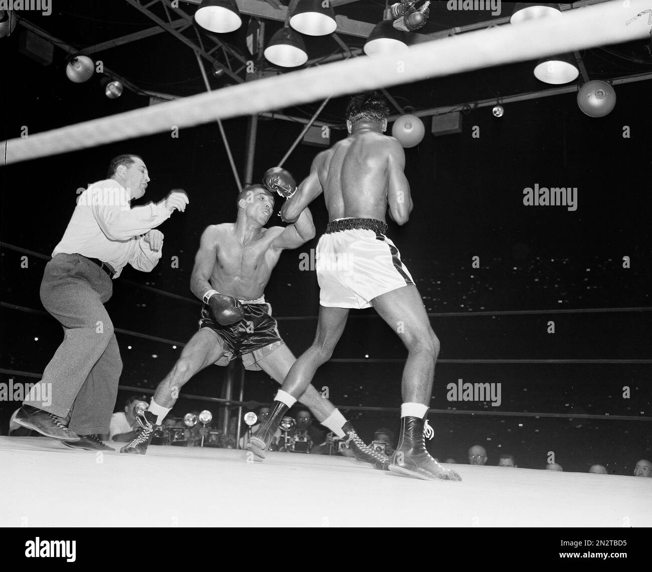 World middleweight boxing champion Randy Turpin, center, and challenger ...