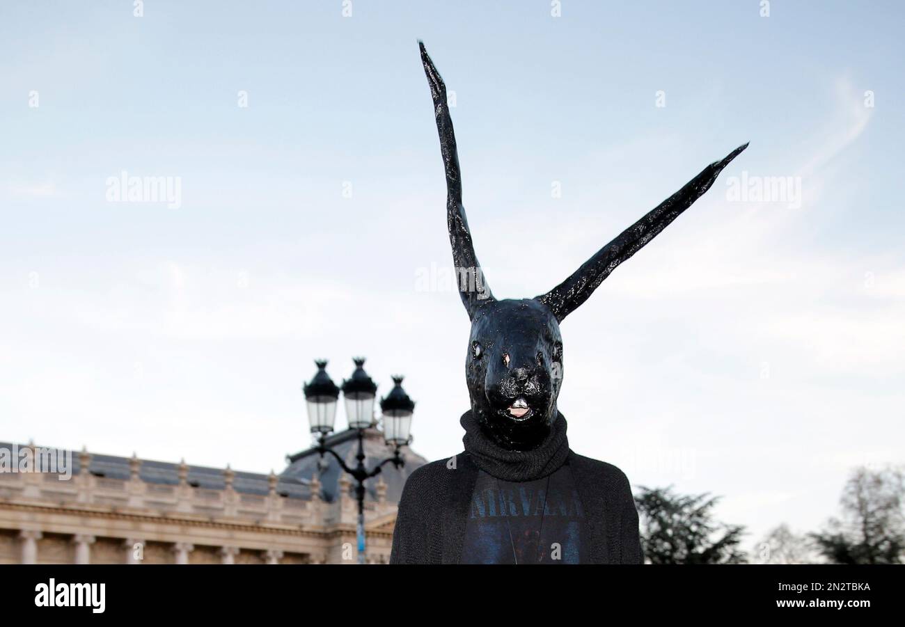 A man in rabbit mask poses for photographers prior to the Maison ...