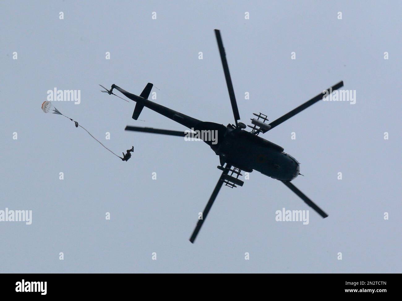 Ukrainian army soldiers drop from a helicopter during a military ...