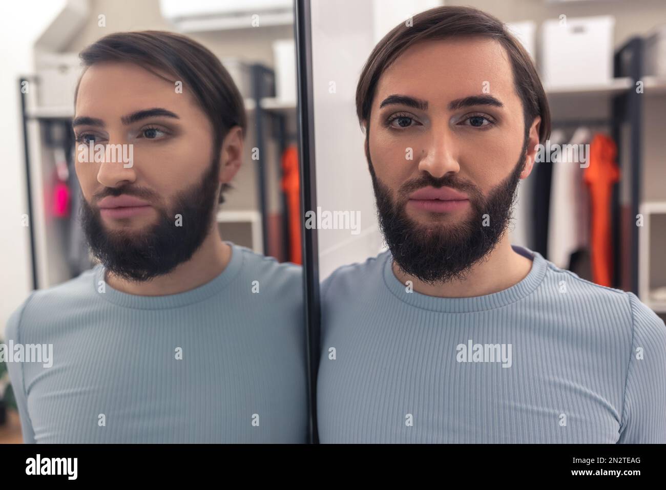Transgender person standing in the fitting room Stock Photo - Alamy