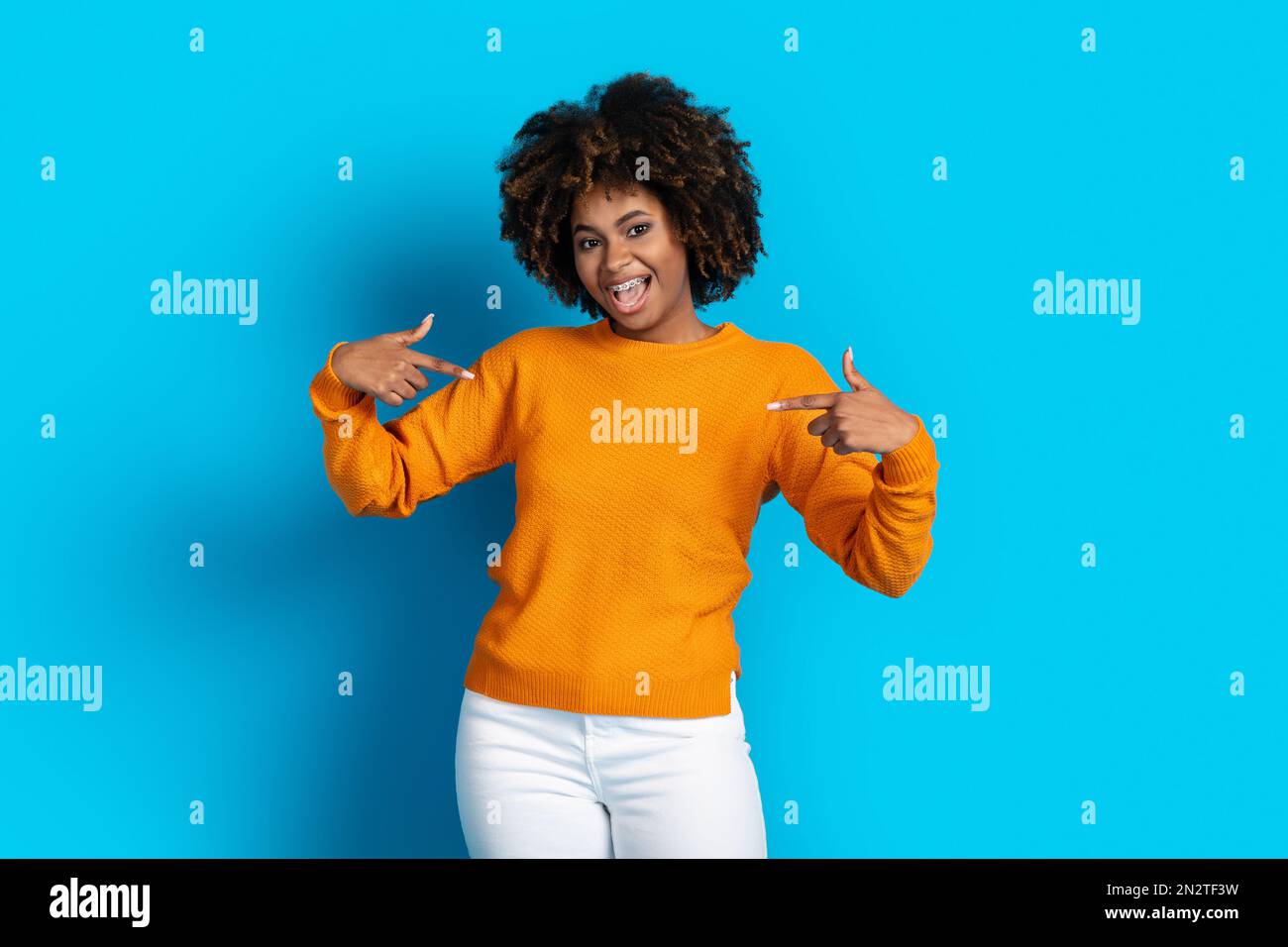 Cool pretty young black lady pointing at herself Stock Photo - Alamy