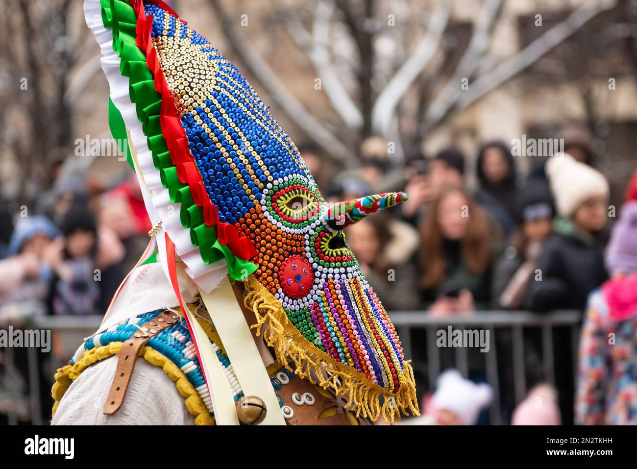 Kukeri dancer wearing colorful intricate mask and costume at Surva ...