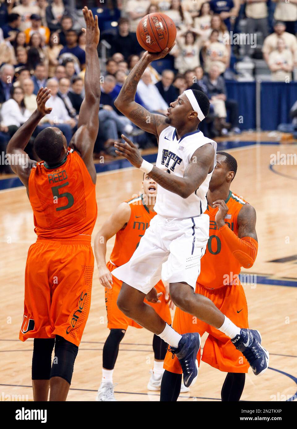 Pittsburgh's Jamel Artis, front right, shoots over Miami's Davon Reed ...