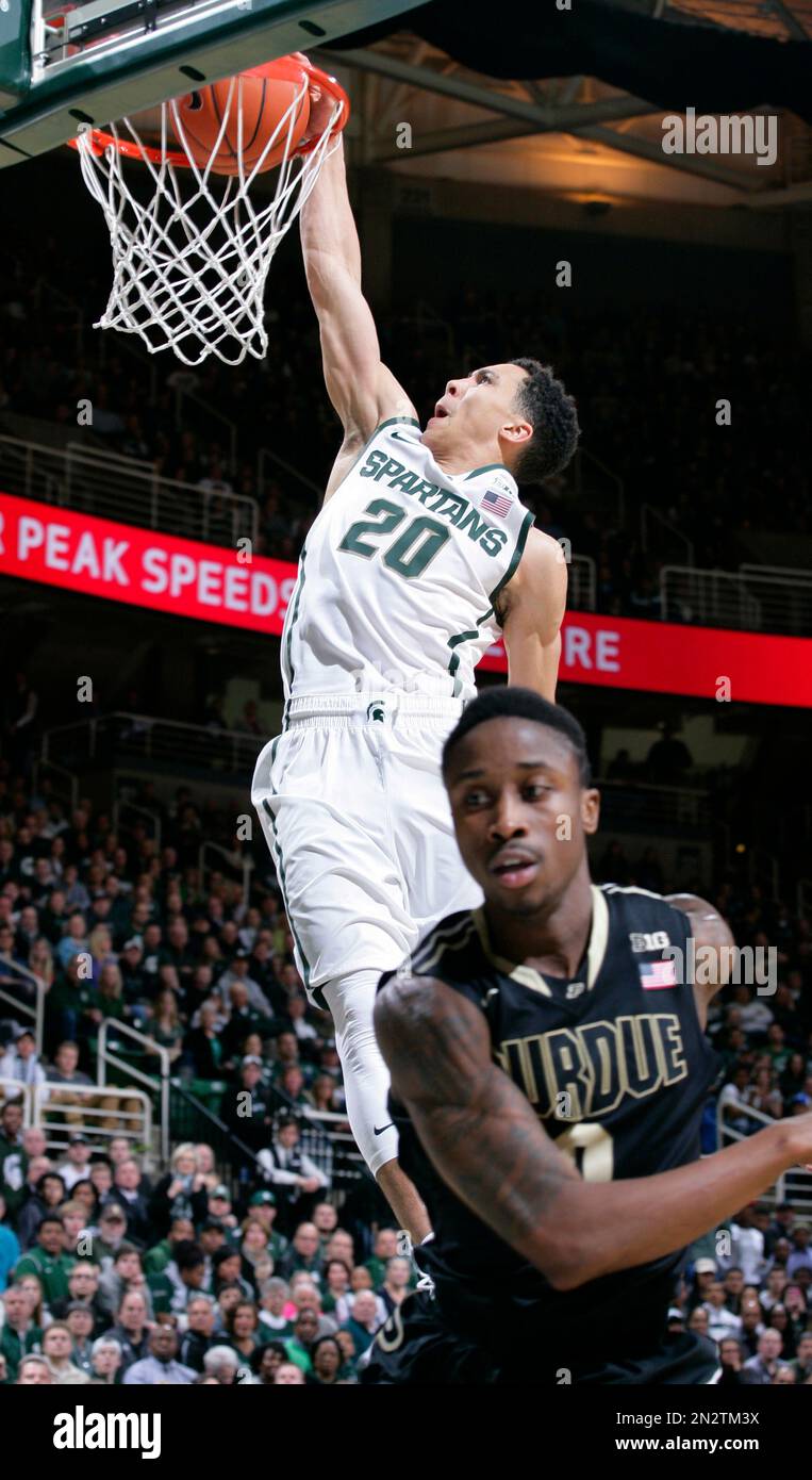 Michigan State's Travis Trice (20) dunks on a fast break over Purdue's ...