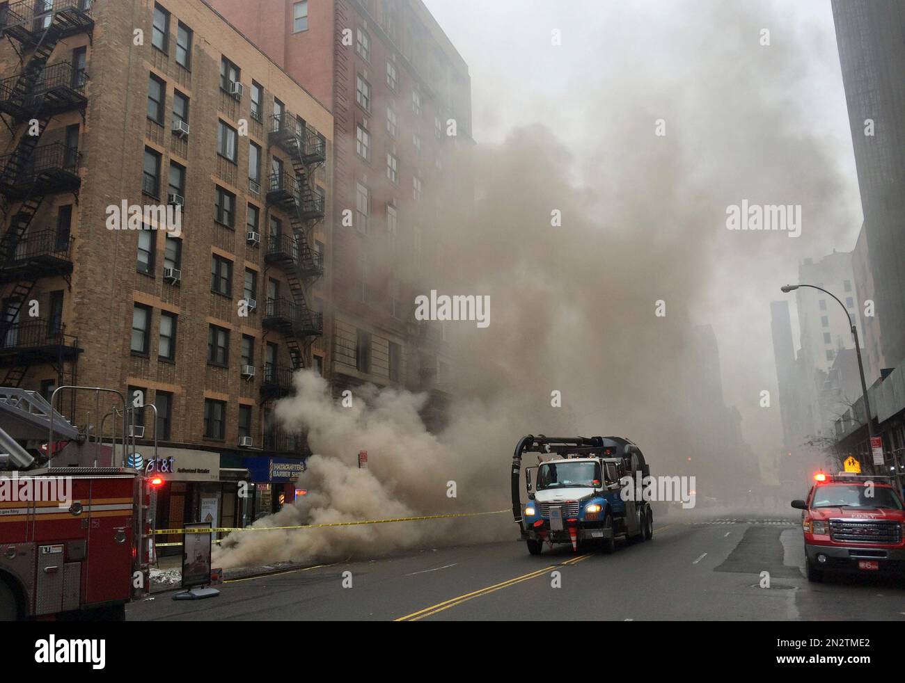 A Con Edison truck pulls up as smoke pours out during a manhole fire ...