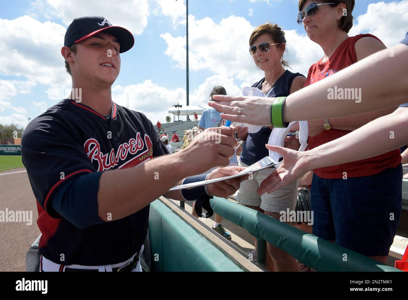 Atlanta Braves catcher Tanner Murphy, left, signs autographs for fans ...