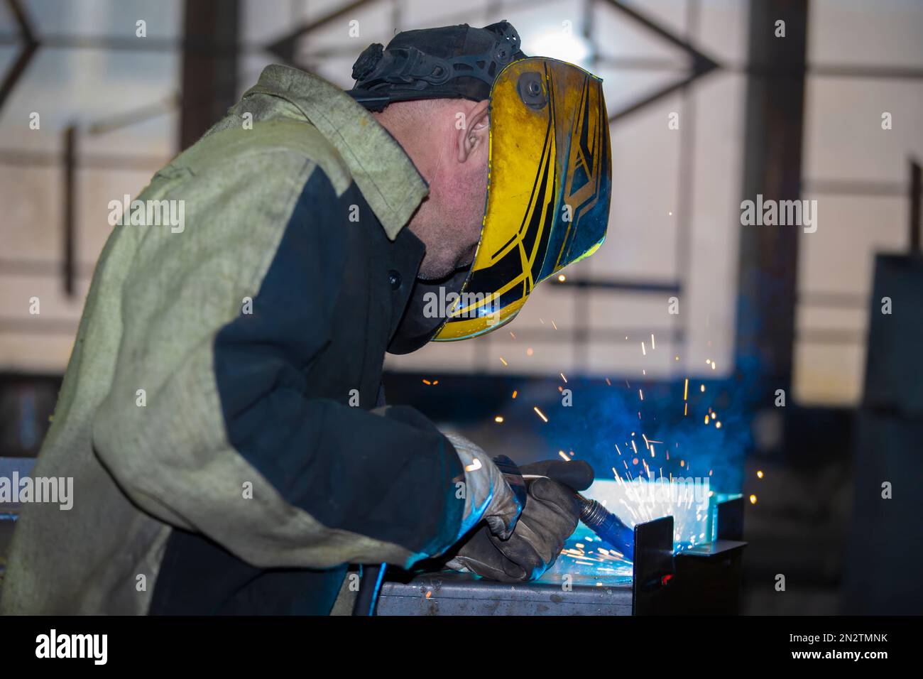 A welder works with metal in a factory shop Stock Photo - Alamy