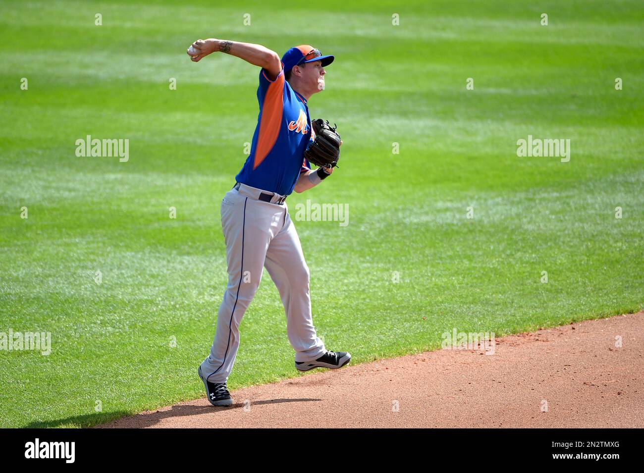 New York Mets shortstop throws to first base after fielding a single ...