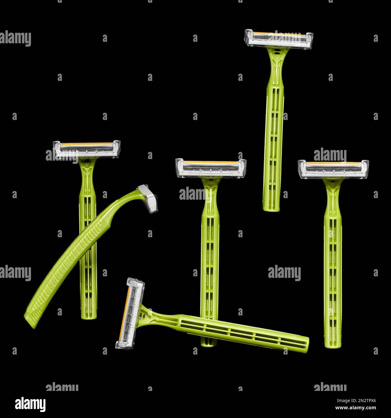 Image of several disposable razors in green on a black background Stock ...