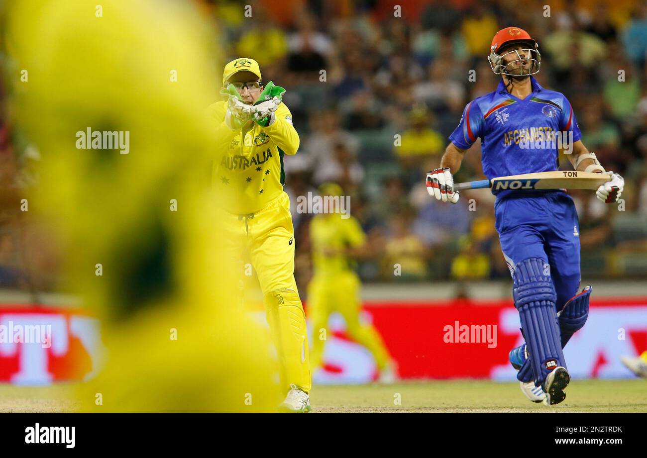 Afghanistan’s Nawroz Mangal completes a run as Australian wicketkeeper ...