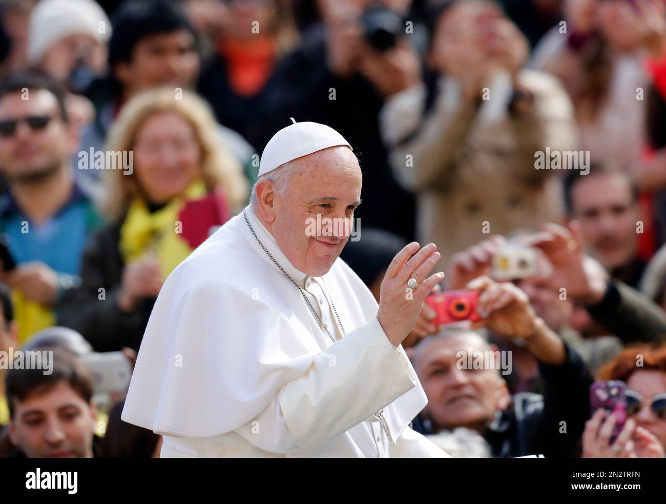 Pope Francis waves to faithful as he arrives for his weekly general ...