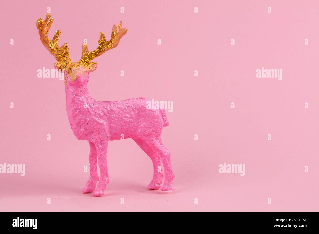 Festive minimalistic Christmas background. On a pink background, a pink ...