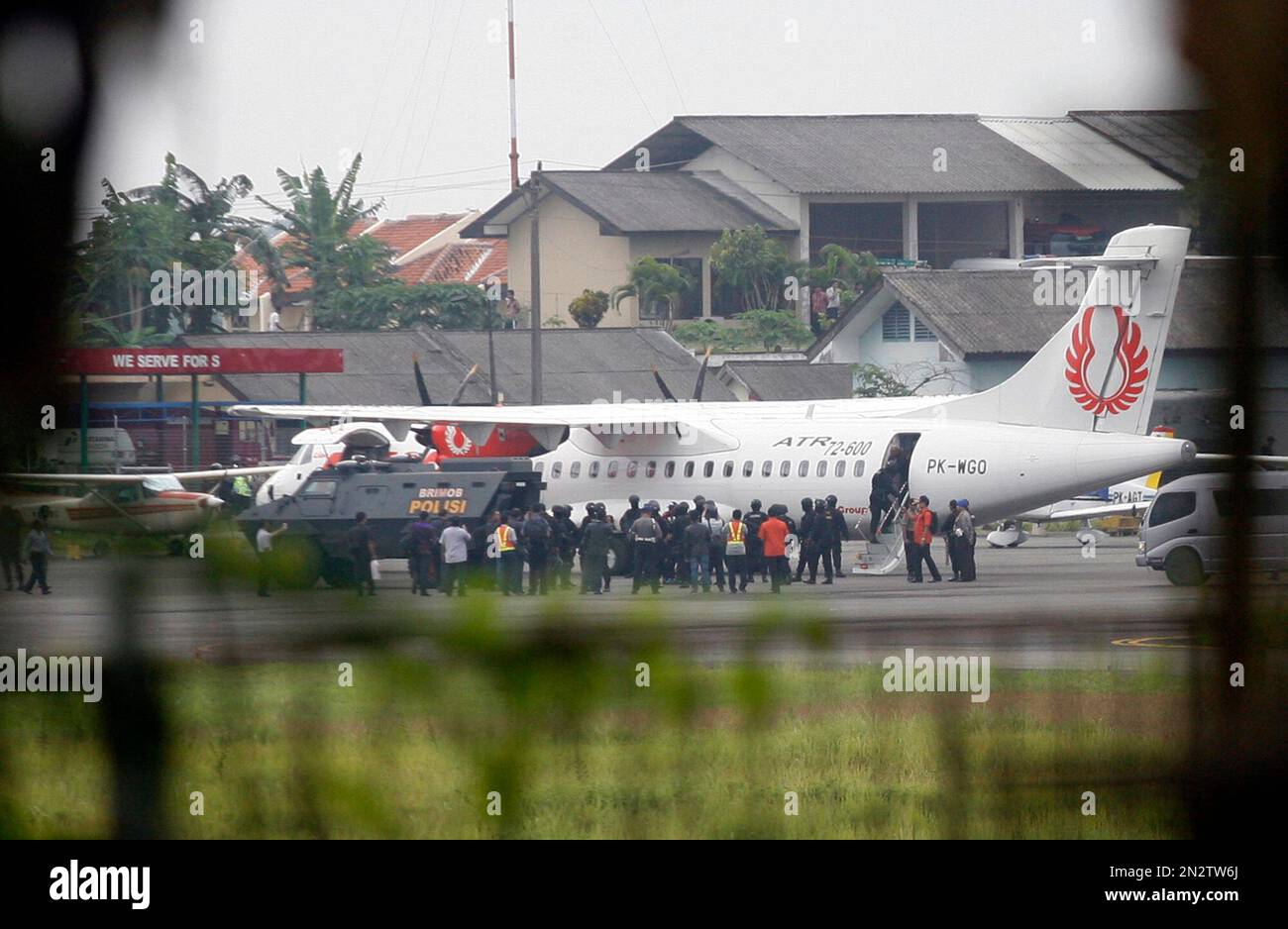 Police gather near an Indonesian police armored vehicle as two ...
