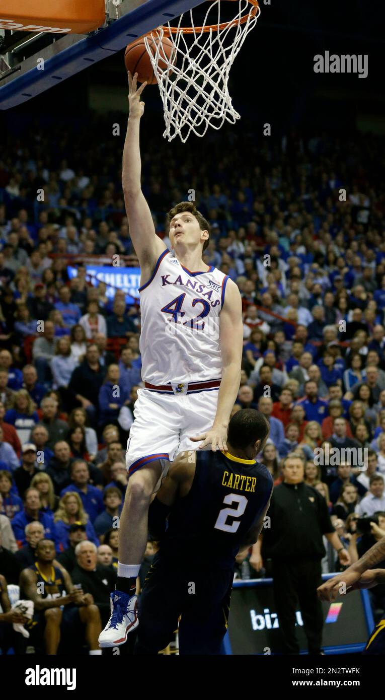 Kansas forward Hunter Mickelson (42) is fouled by West Virginia guard ...