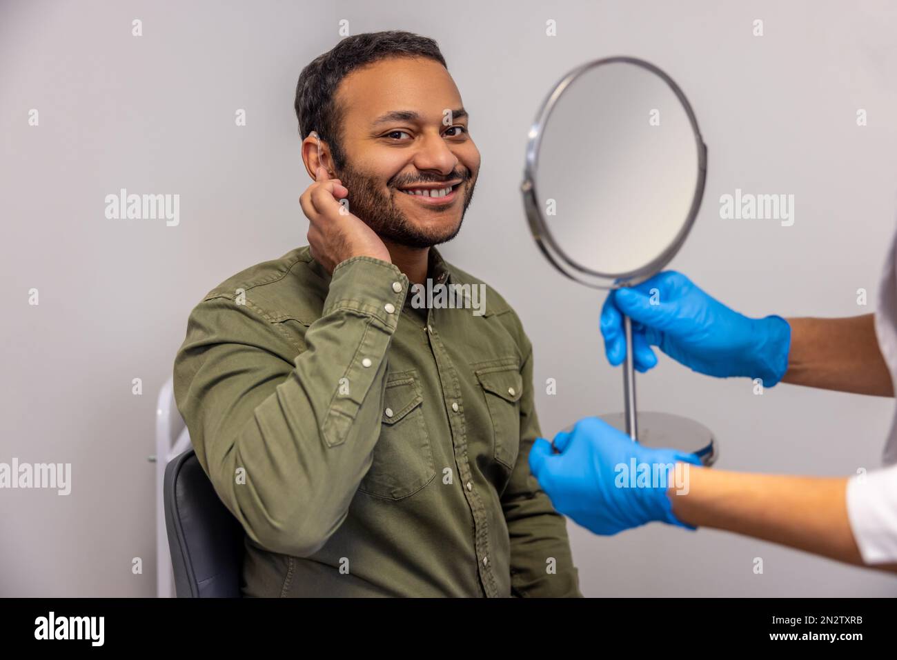 Doctor holding a mirror and showing the result to the patient Stock ...