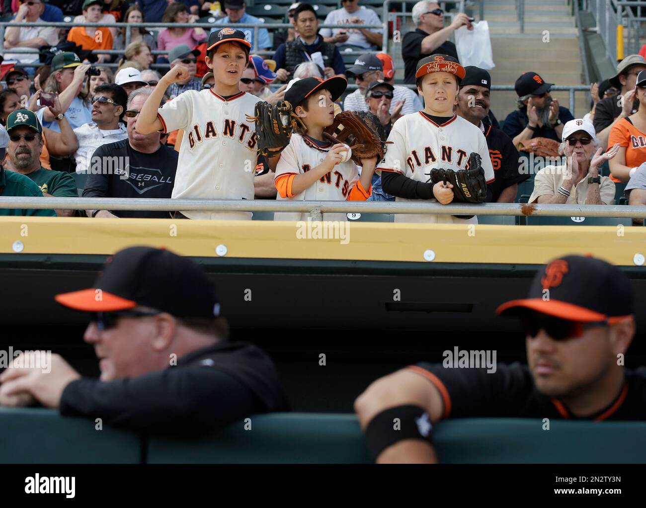 Young San Francisco Giants fans wait behind the dugout of the Giants ...