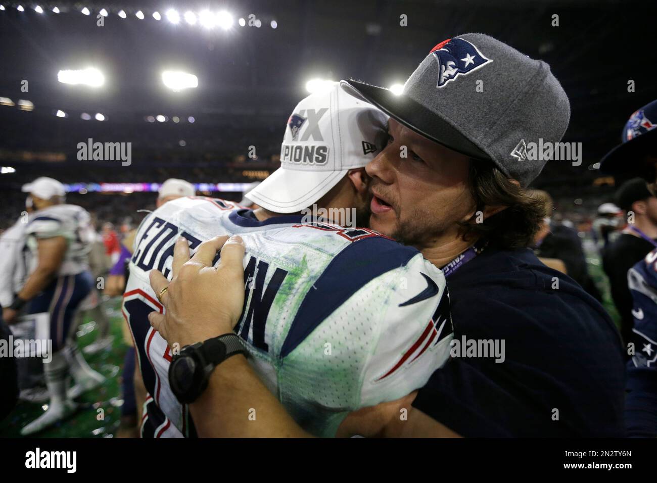 New England Patriots' Julian Edelman hugs actor Mark Wahlberg after the ...