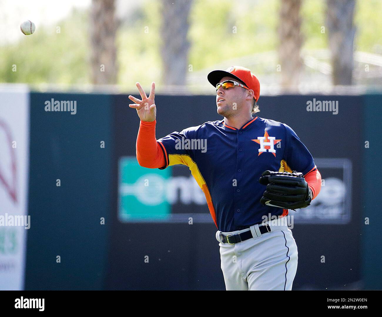 Houston Astros' George Springer tosses the ball after fielding a fly ...