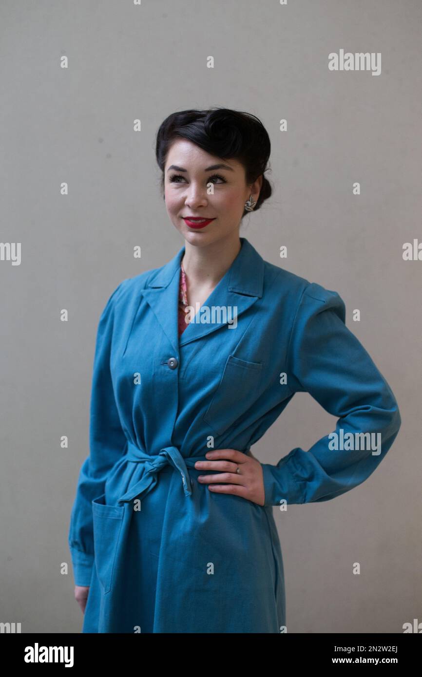 A model dressed in 1940s style clothing poses for pictures inside the ...