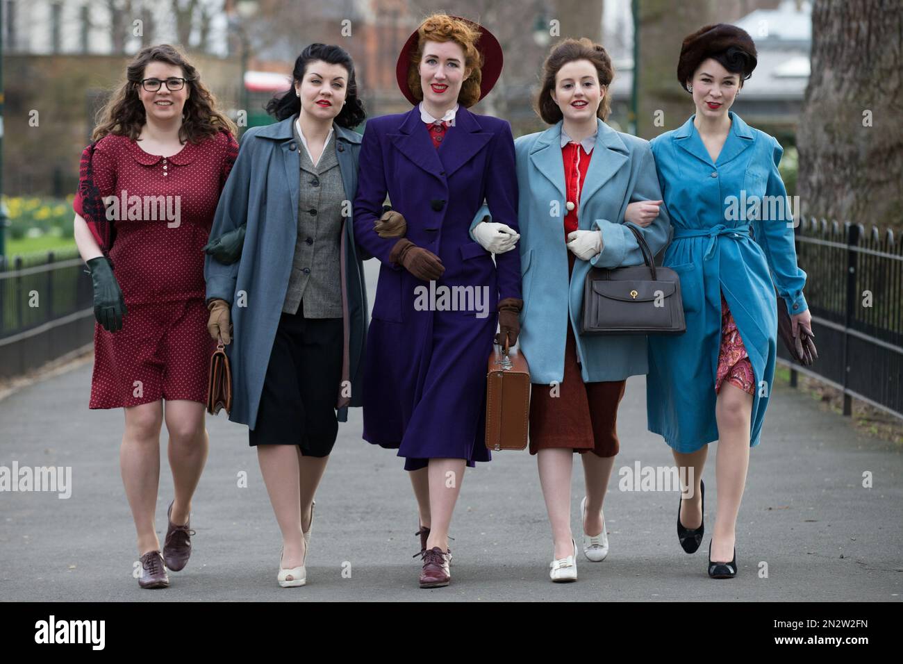 Models dressed in 1940s style clothing pose for pictures outside the ...