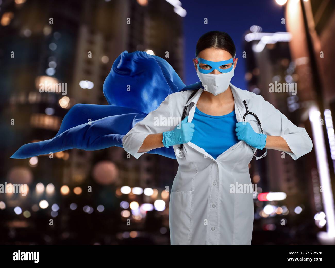 Doctor dressed as superhero on night city background. Medical workers ...