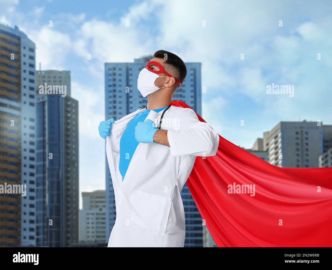 Doctor dressed as superhero on city background. Medical workers ...
