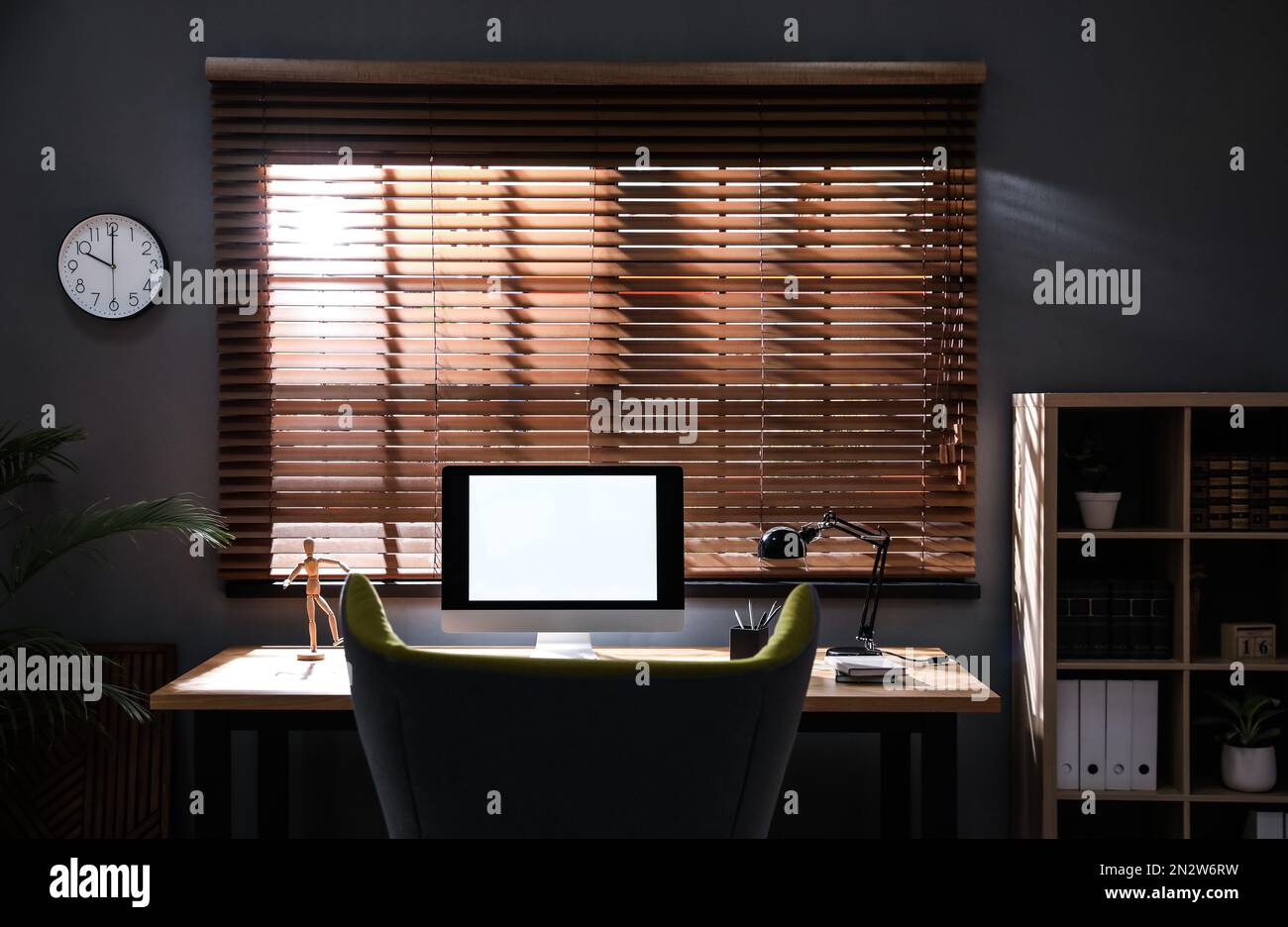 Stylish room interior with modern computer and comfortable office chair ...