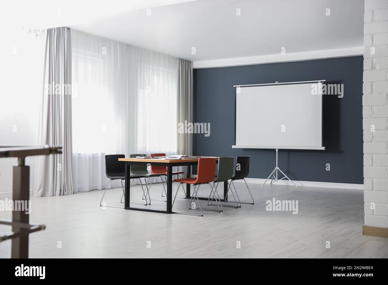 Modern meeting room interior with large table and projection screen ...