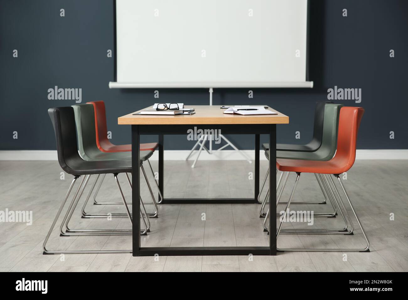 Modern meeting room interior with large table and projection screen ...