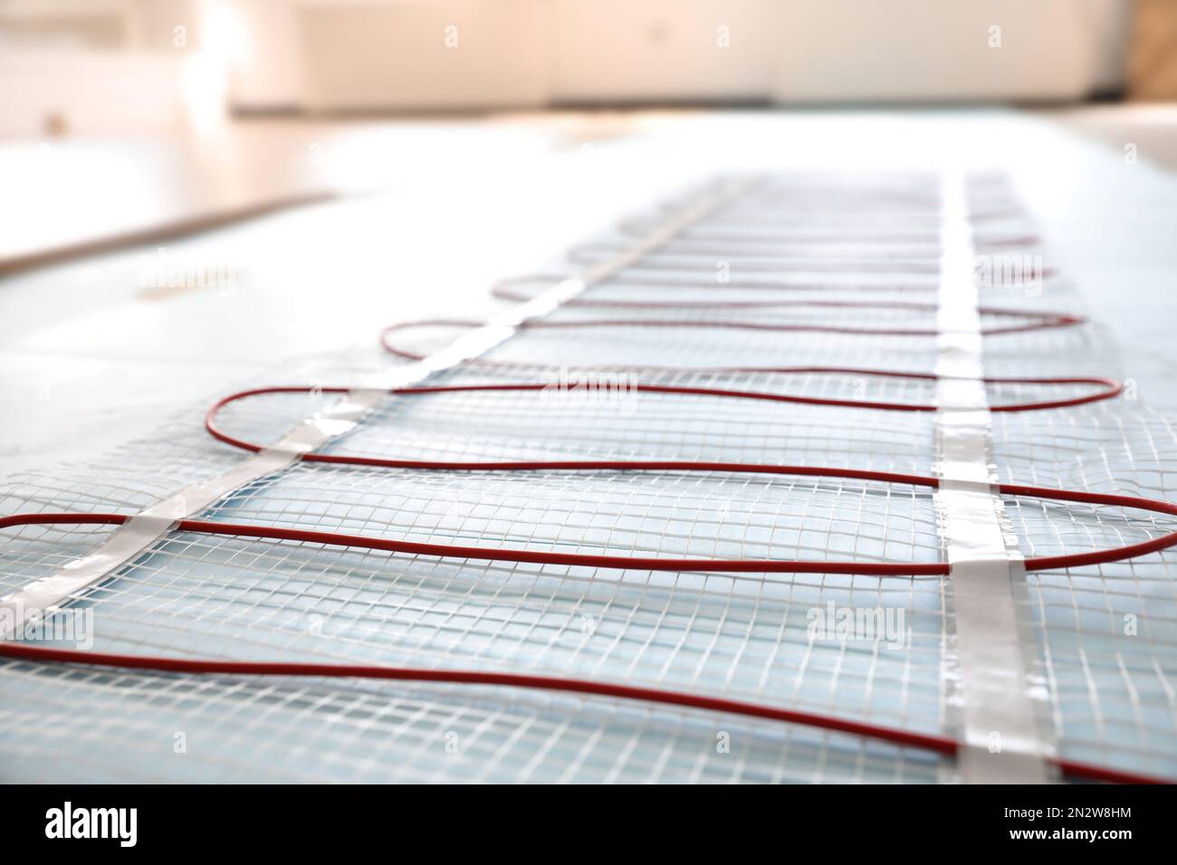 Installation of modern underfloor trace heating system indoors, closeup ...