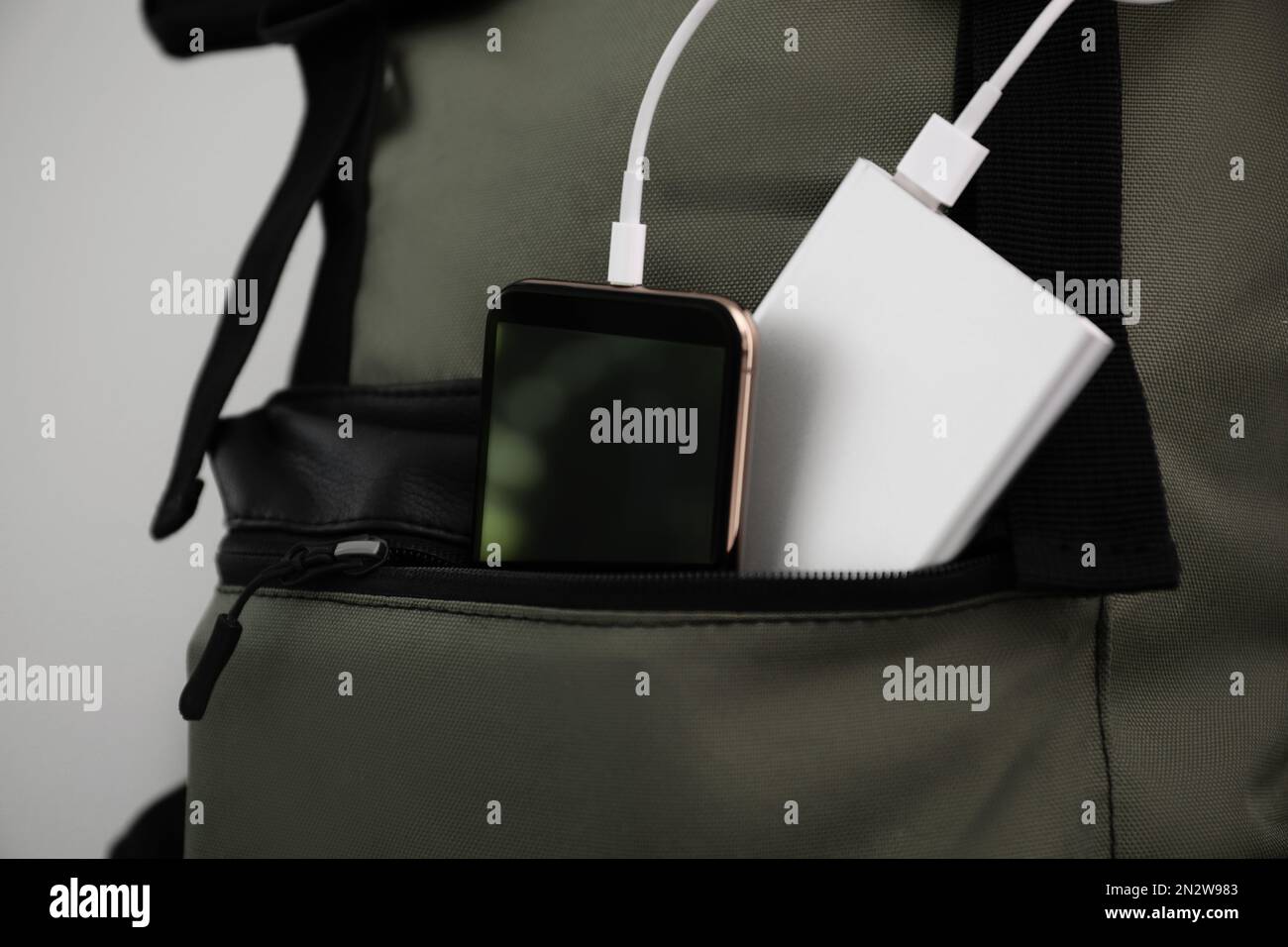 Smartphone charging with power bank in backpack, closeup Stock Photo ...