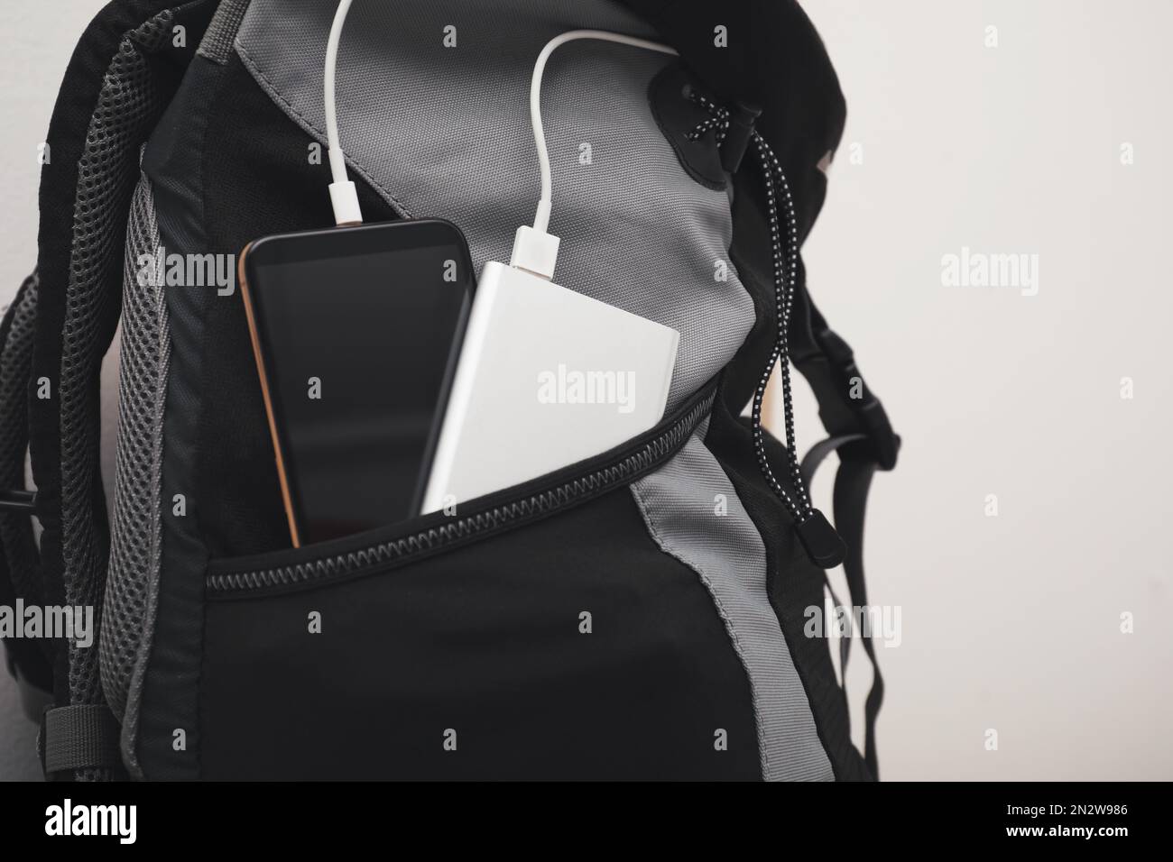 Smartphone charging with power bank in backpack, closeup Stock Photo ...